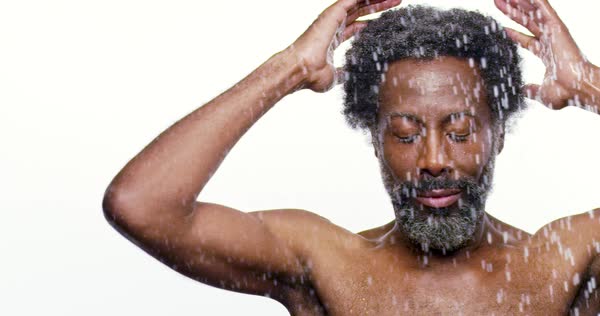 A man running his hands through his hair in a rainfall - HD Royalty ...