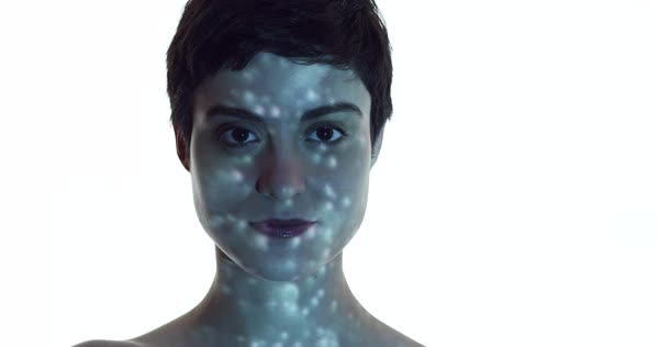 A young woman looking at camera with waves projected over her face ...