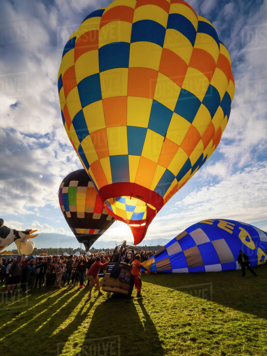 Ground level view of a hot air balloon lifting off at Sunrise ...