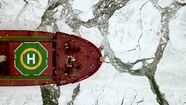Drone top down Epic red steel icebreaker ship tanker breaks winter ...