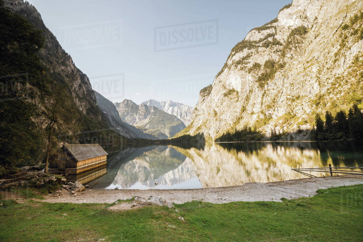 Covered pier over a German lake among the mountains at sunset with ...