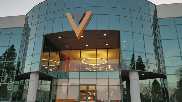 Panning from logo to entrance at facade of headquarters of life ...