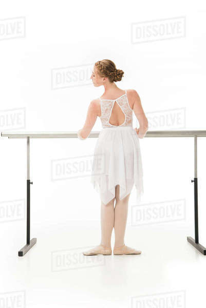 Rear view of elegant ballerina in tutu and pointe shoes practicing at ...