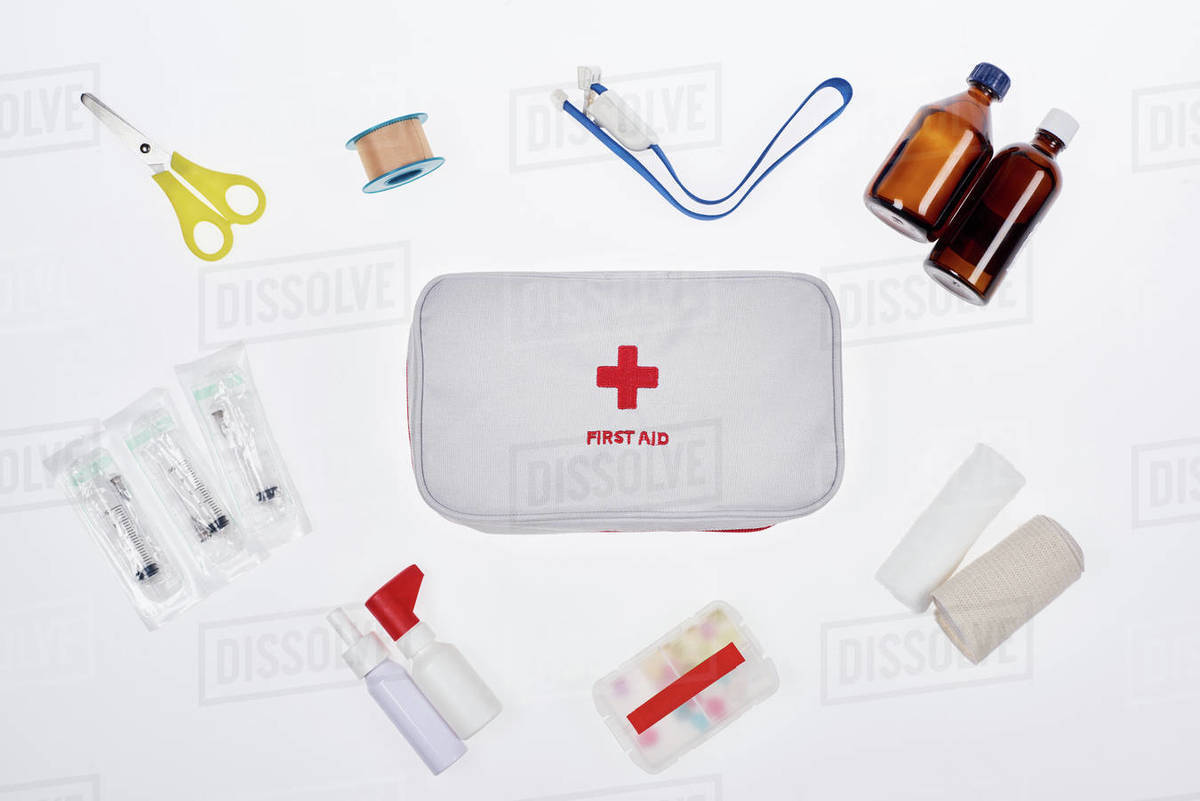 flat lay with automotive first aid kit with various medicines isolated ...