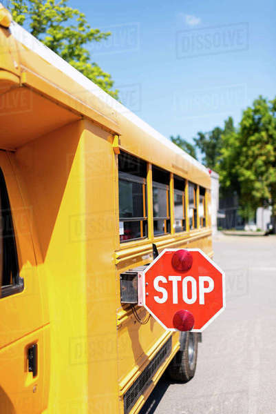 cropped shot of traditional school bus with stop sign - Royalty-free ...