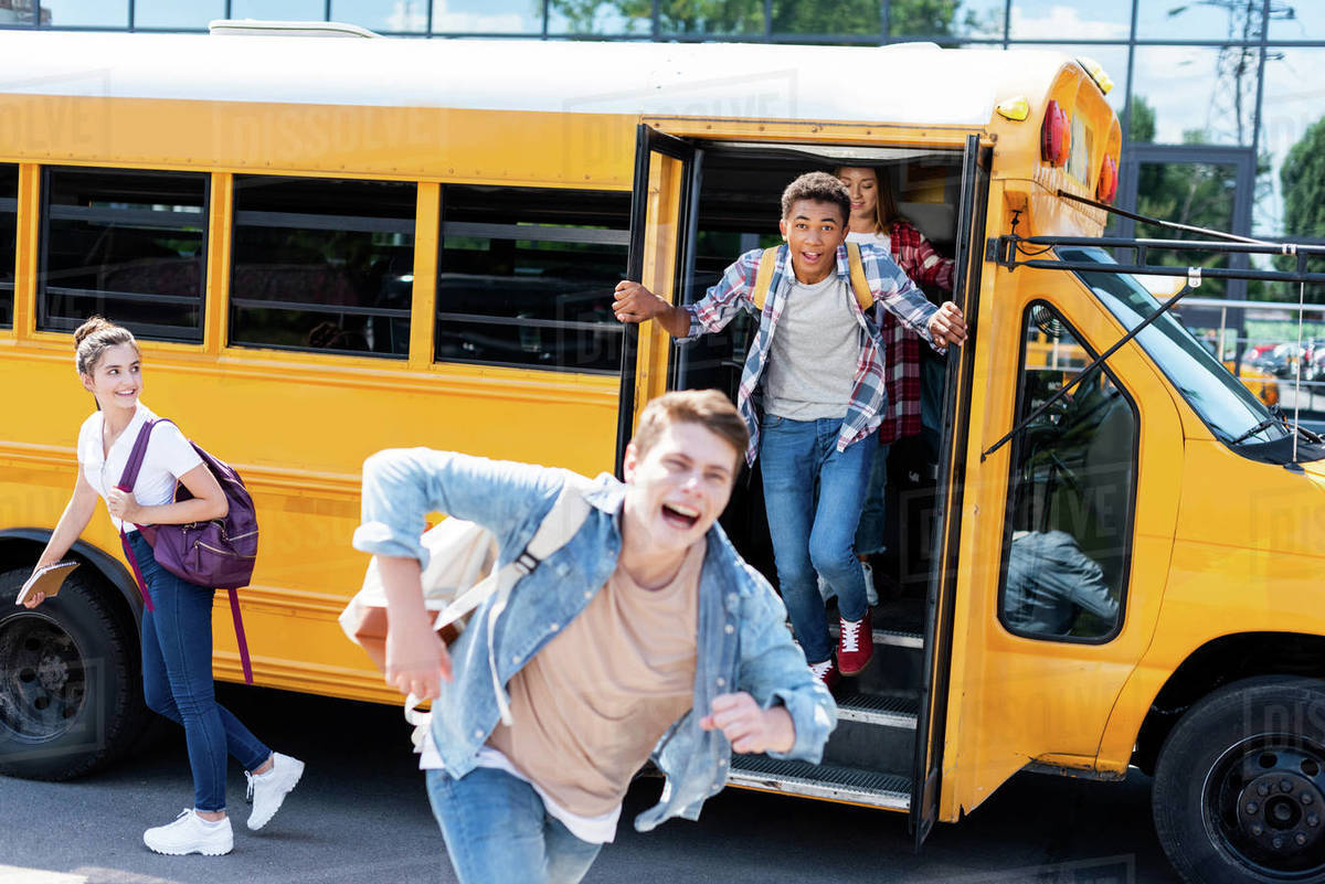 group of teen scholars running out school bus and screaming - Royalty ...