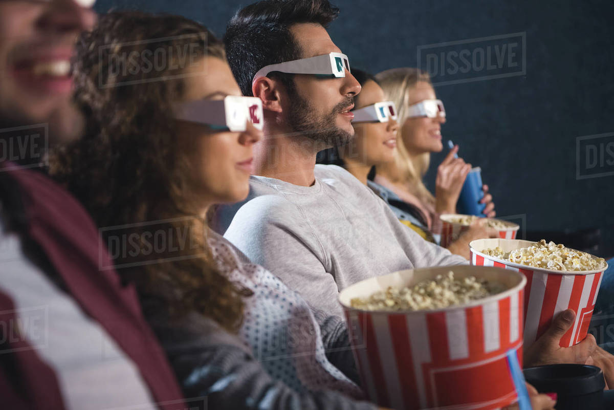Multiethnic friends in 3d glasses with popcorn watching film together in movie theater - Stock ...