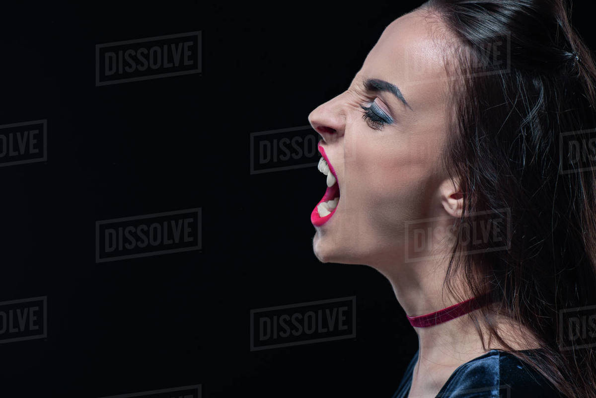 Mystic woman showing vampire fangs isolated on black - Royalty-free ...