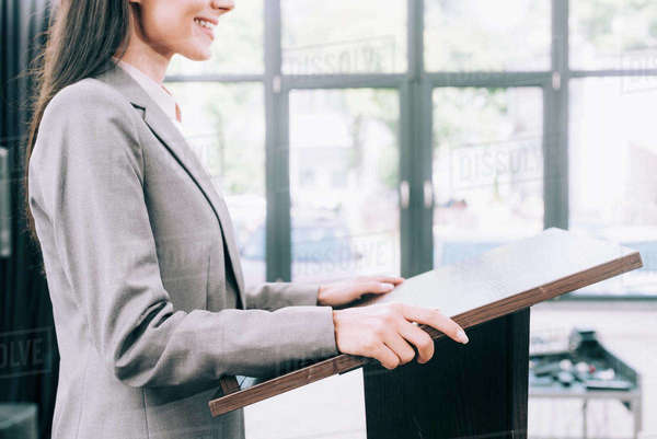 Cropped image of smiling lecturer standing at podium tribune during ...