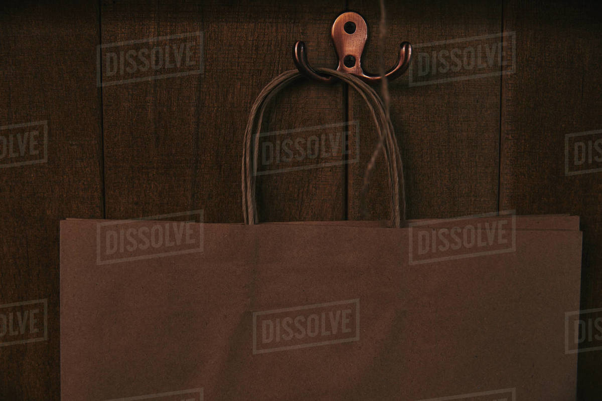 Close-up shot of blank paper bag hanging on wooden wall - Stock Photo ...