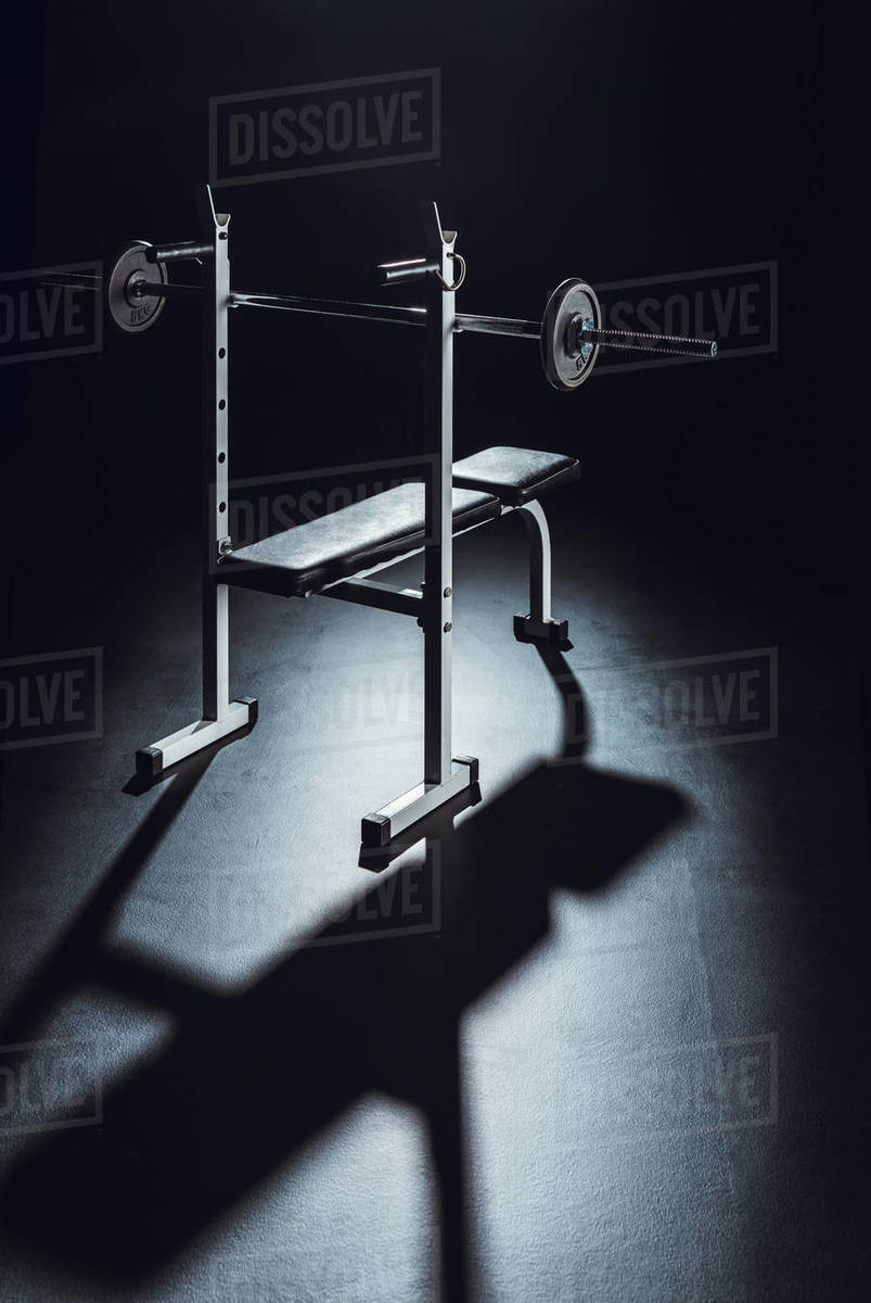 Barbell with shadow on floor at gym, black background - Stock Photo ...