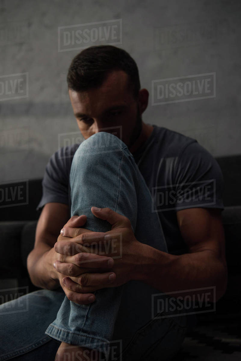 Upset depressed man sitting at home, selective focus - Royalty-free ...