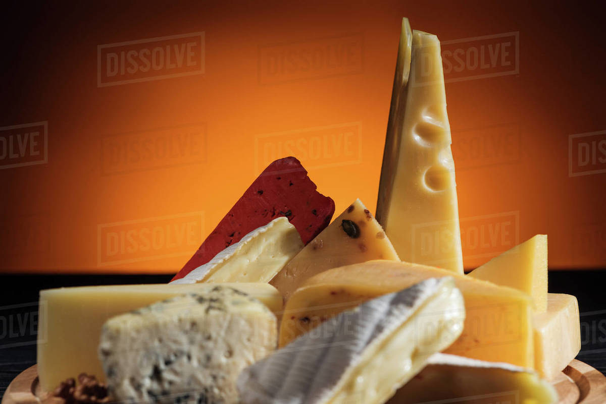 Different types of tasty cheeses on orange - Royalty-free Stock Photo ...