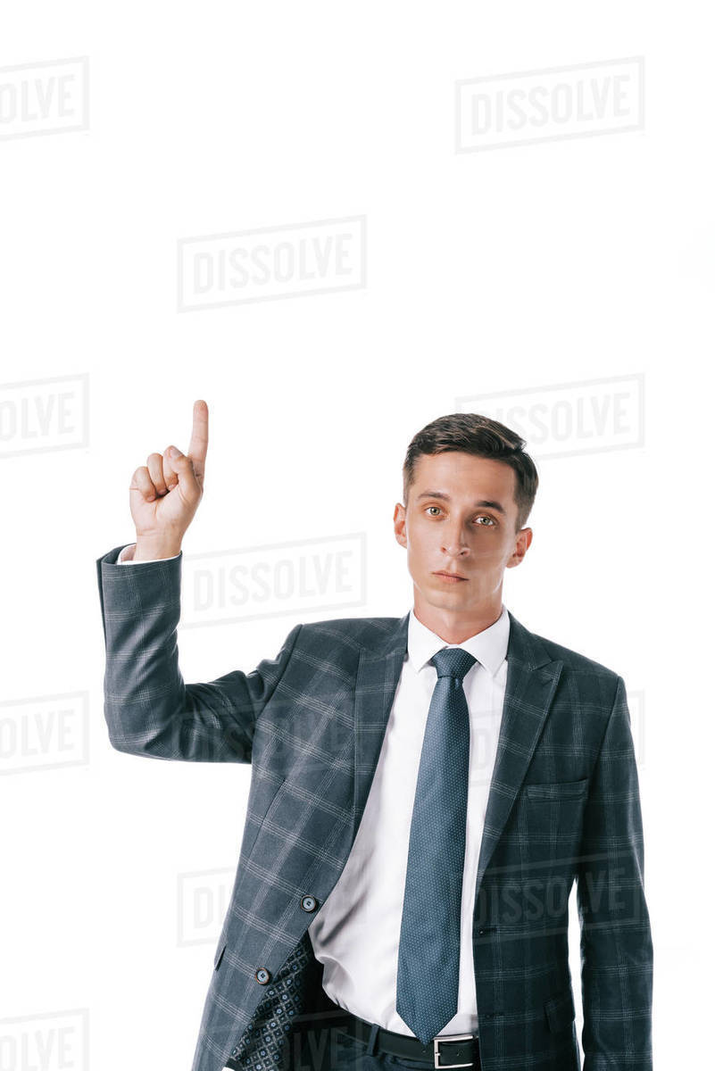 Portrait of businessman in suit pointing up isolated on white - Stock ...