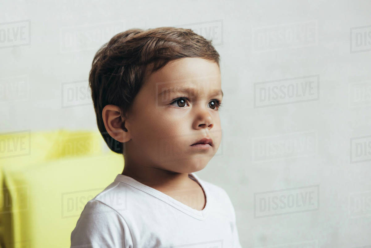 Portrait of adorable toddler looking away at home - Stock Photo - Dissolve