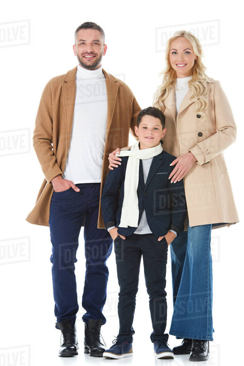 Parents in beige coats hugging son in autumn outfit, isolated on white ...