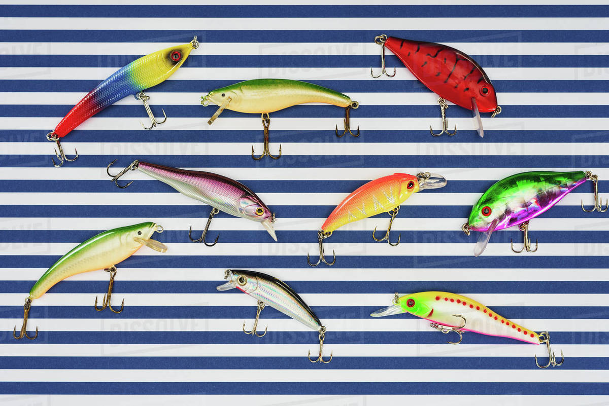 Elevated view of various fishing bait on striped background - Royalty ...