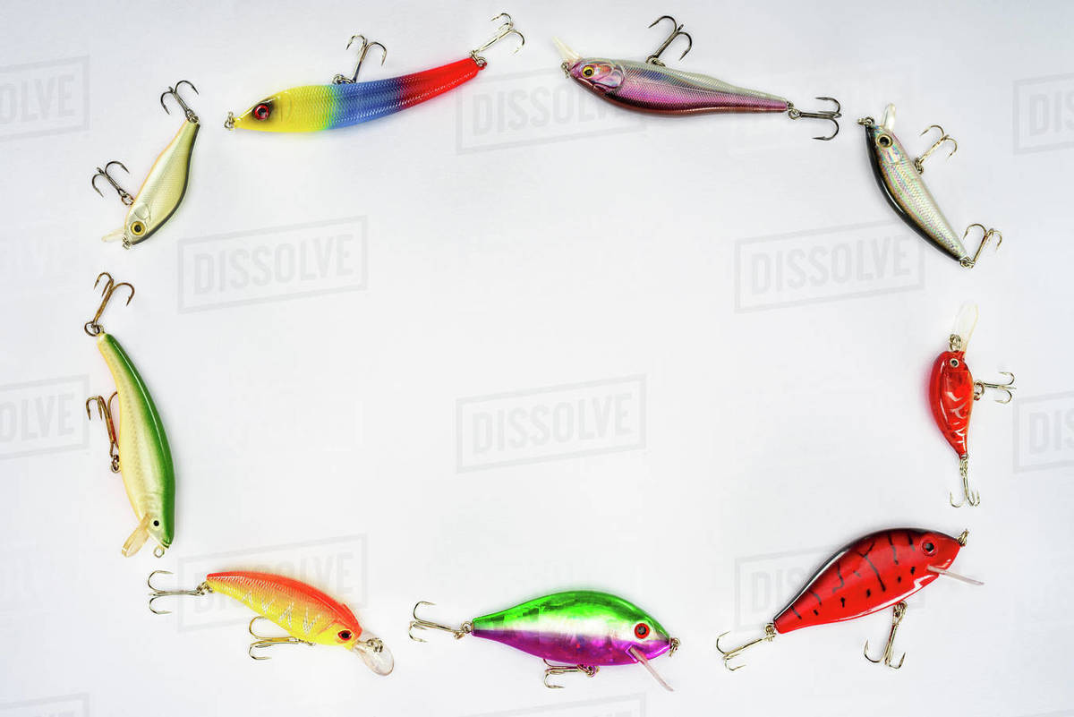 Top view of circle made of various fishing bait isolated on white ...