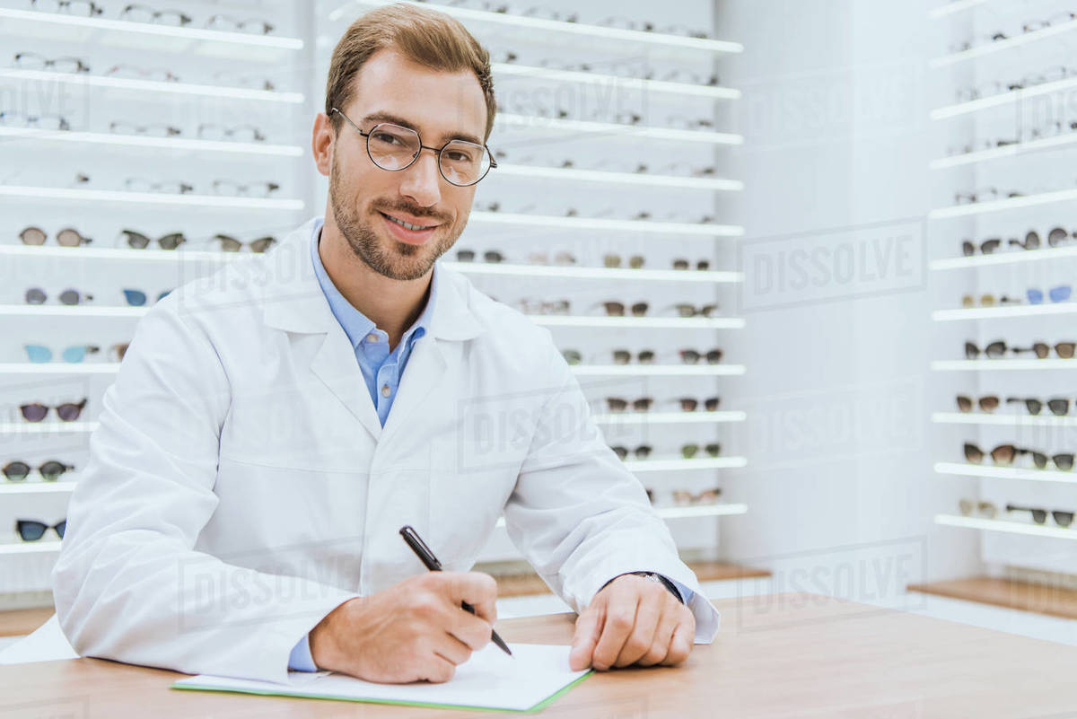 Professional optometrist writing diagnosis in ophthalmic shop - Royalty ...