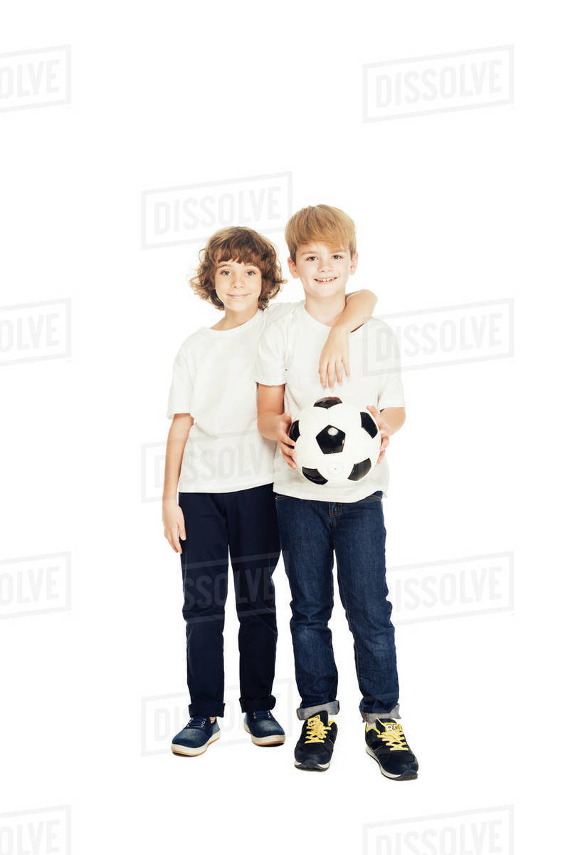 Adorable boys hugging and holding football ball isolated on white ...