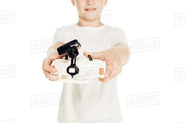 Cropped image of boy holding remote control isolated on white - Royalty ...