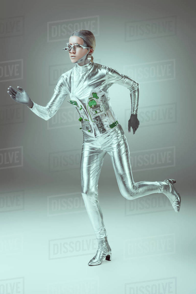 Full length view of silver woman robot running on grey, future ...