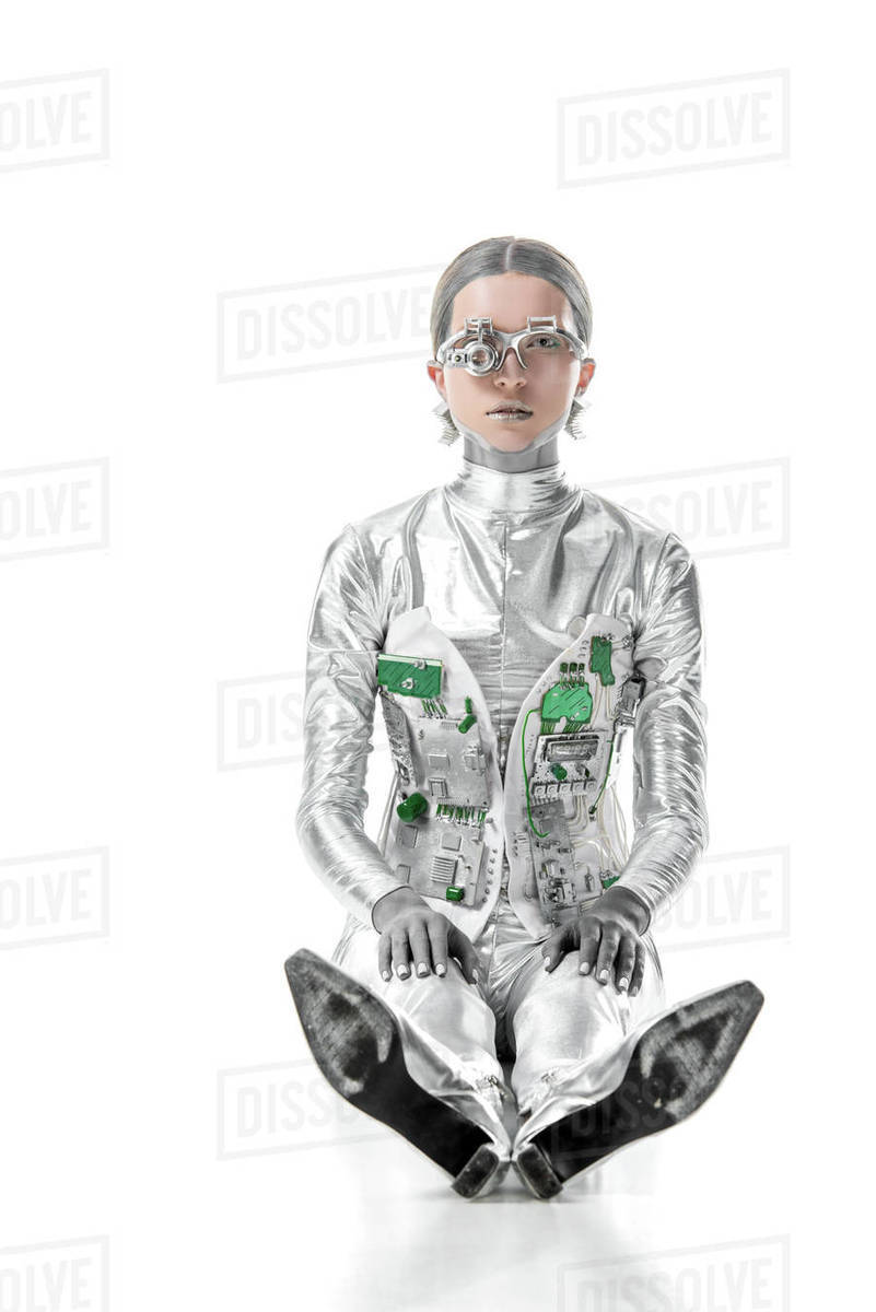 Silver robot sitting and looking at camera isolated on white, future ...