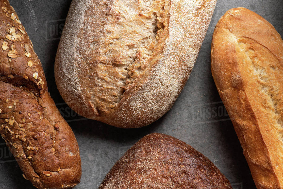 Flat lay with loafs of baked bread on grey tabletop - Royalty-free ...