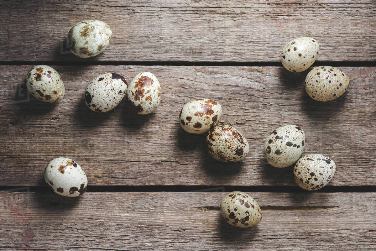 Top view of fresh raw healthy quail eggs on rustic wooden table ...