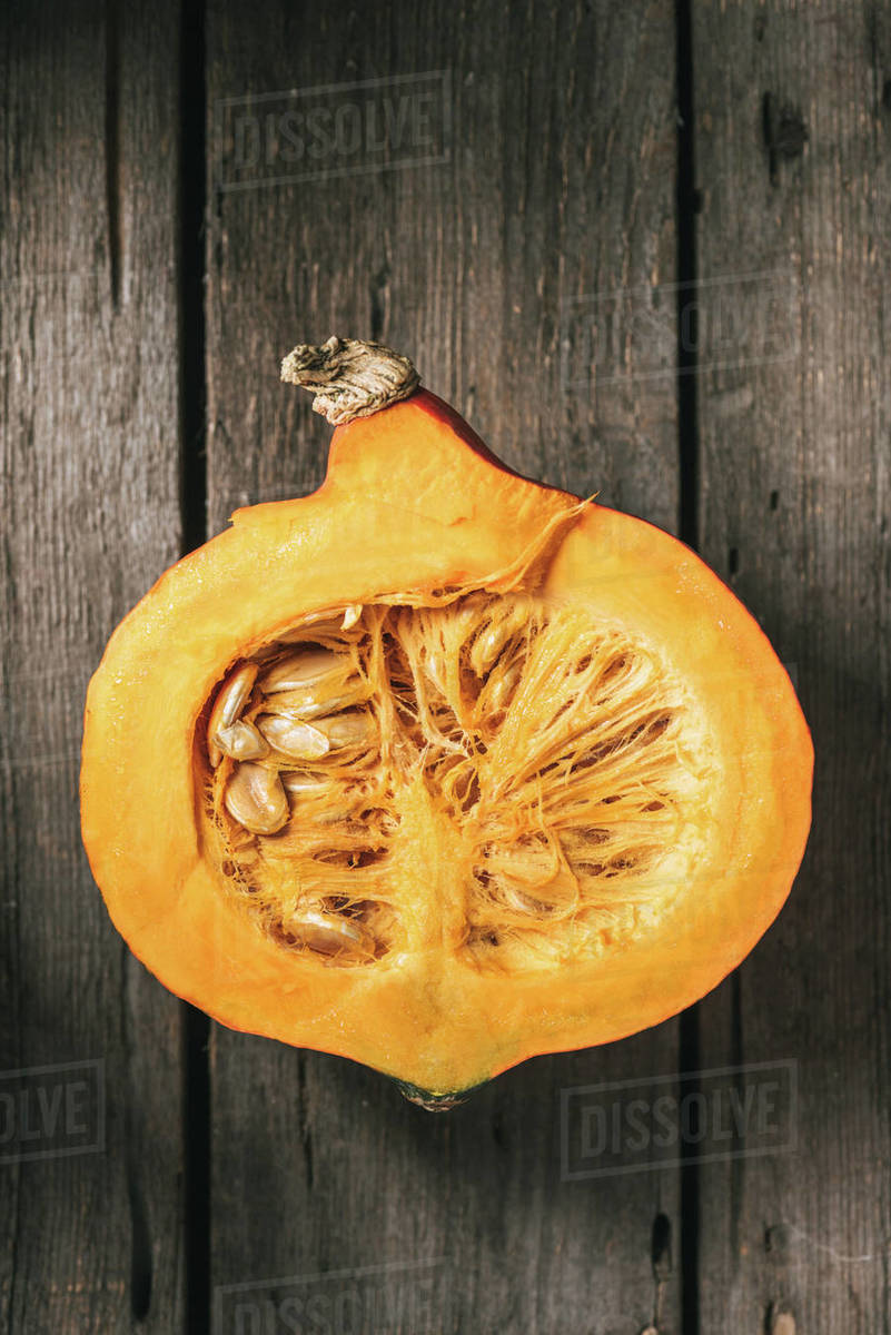 Top view of cut pumpkin half on wooden background - Royalty-free Stock ...