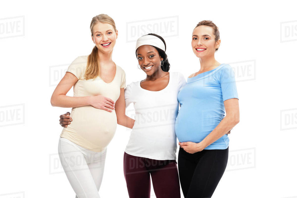 Three pregnant women standing and hugging isolated on white - Royalty ...