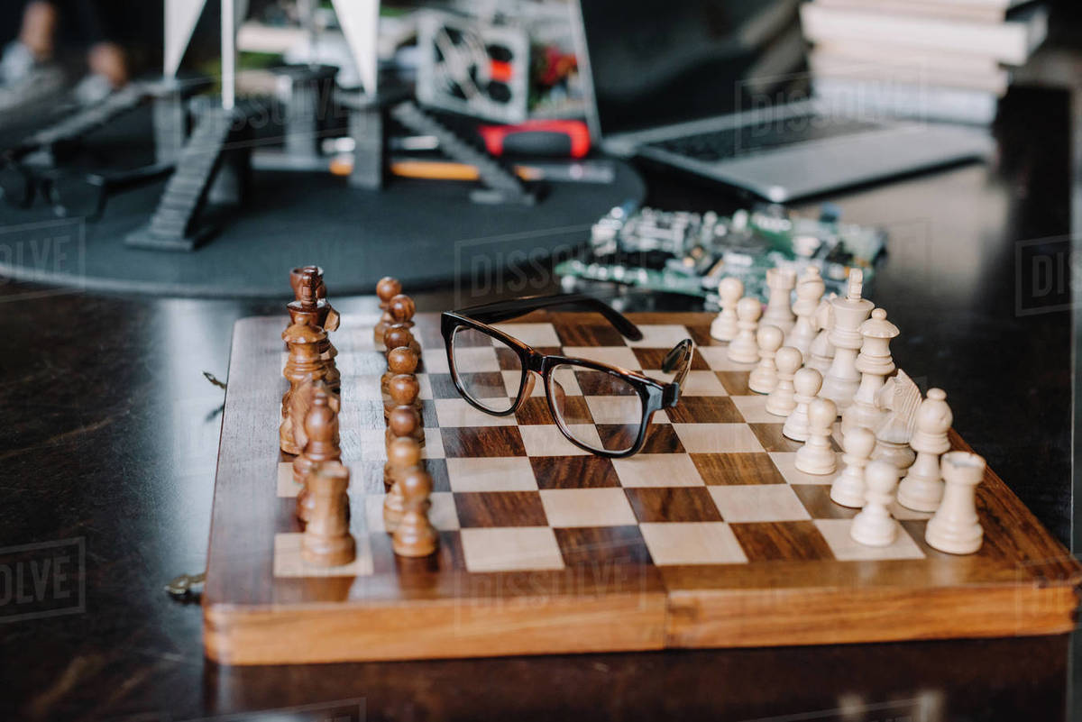 Wooden chess board with glasses on table in living room - Royalty-free ...