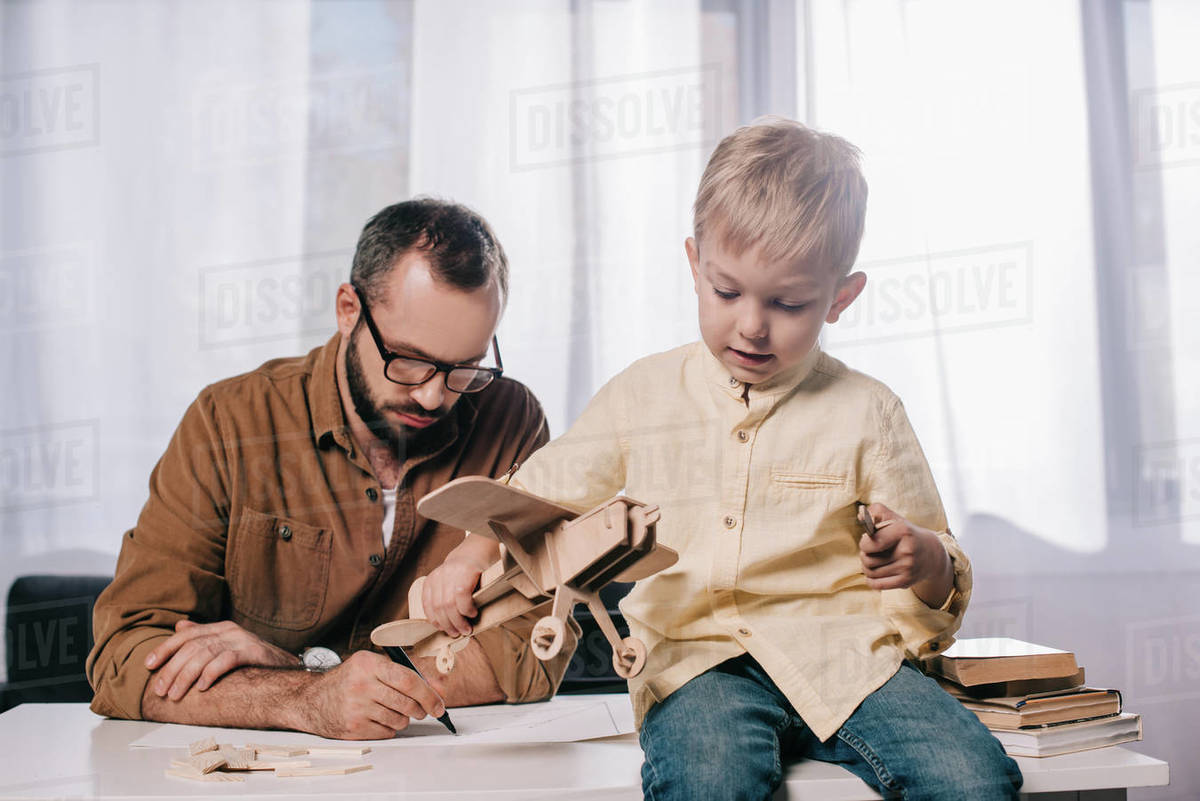 Father and adorable little son modeling together at home - Royalty-free ...