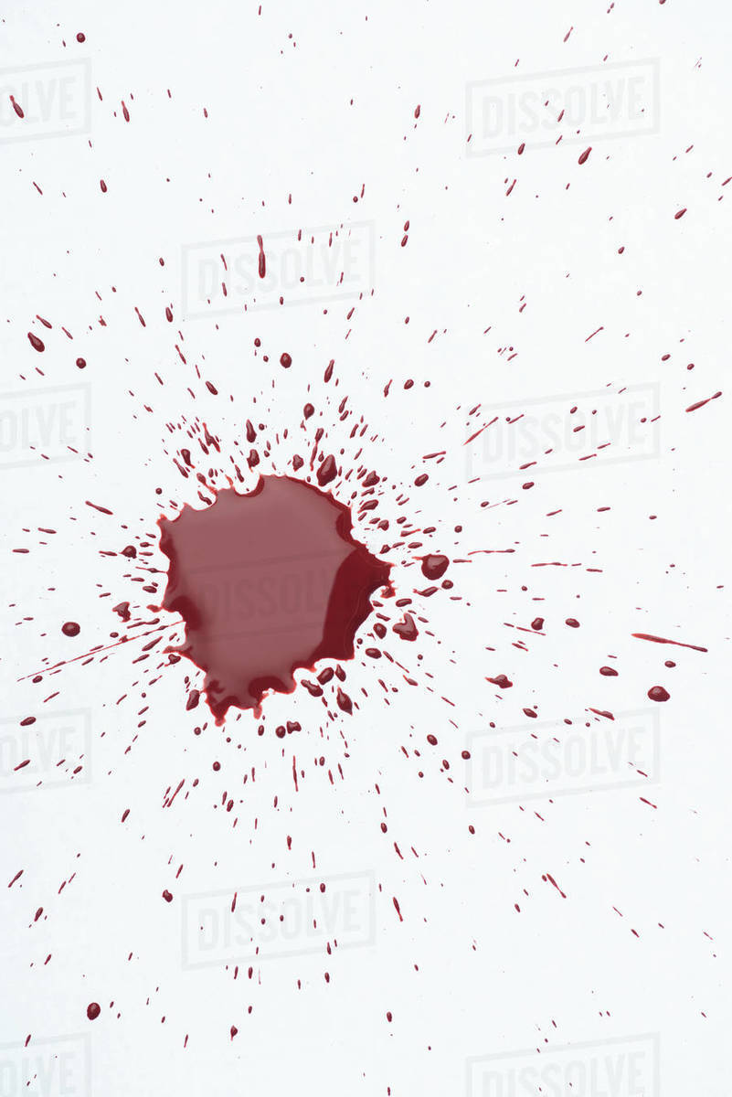 top view of messy blood splash with small droplets on white surface ...