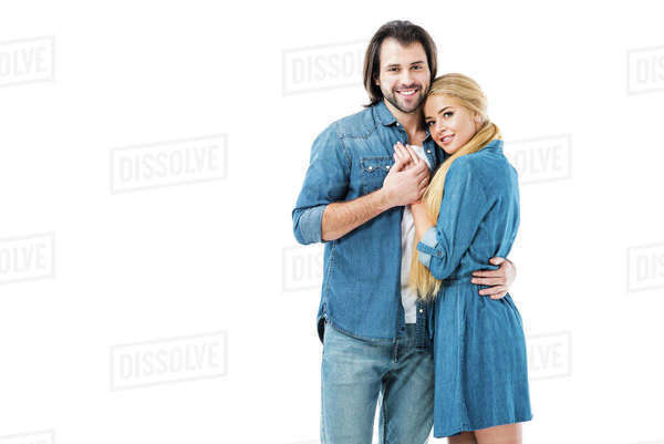 Lovely couple in jeans holding hands and hugging isolated on white ...
