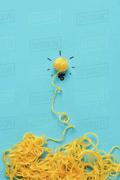 light bulb sign made of yellow yarn on blue background, ideas concept ...
