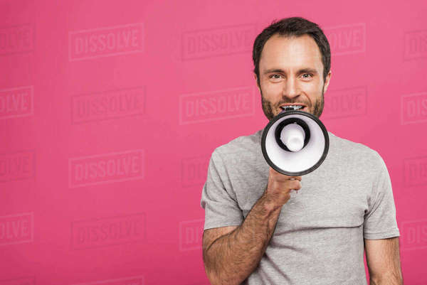 Happy handsome man speaking with megaphone, isolated on pink - Royalty ...