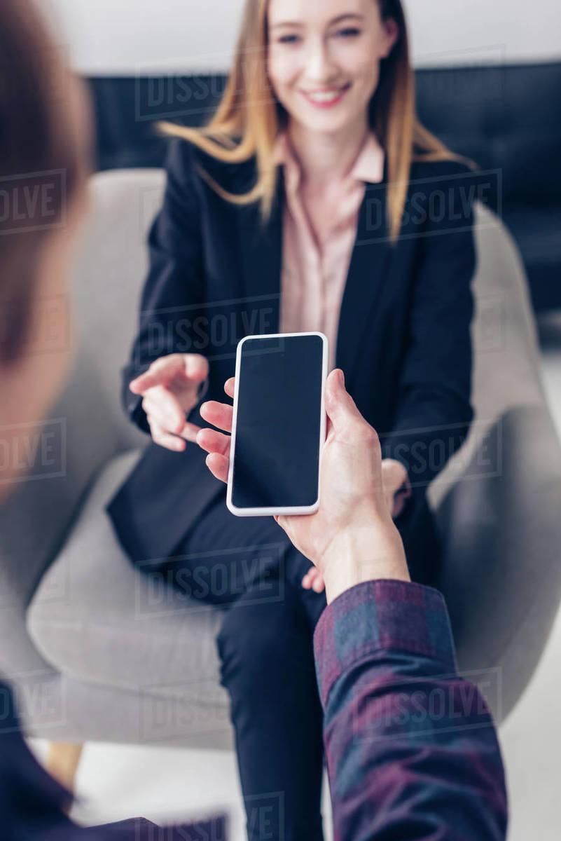 Selective focus of journalist recording interview with businesswoman on ...