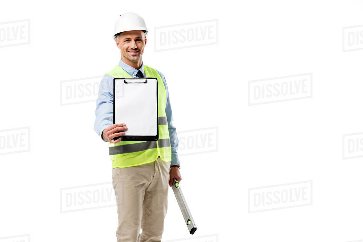 Smiling engineer holding clipboard with blank sheet and spirit level ...