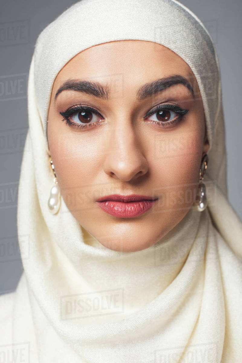 Close-up portrait of beautiful young muslim woman looking at camera ...