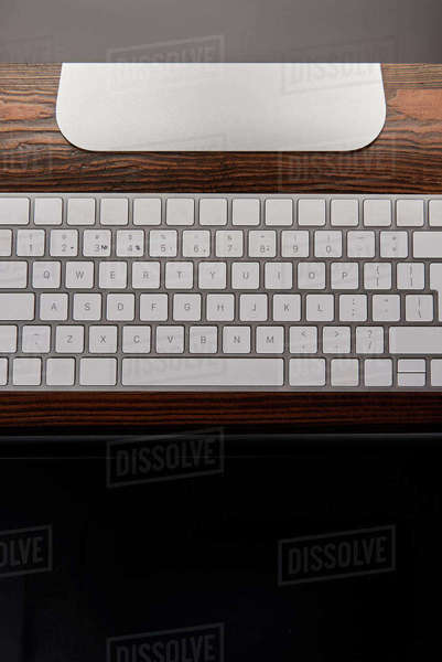 Top view of computer keyboard with graphics tablet on wooden table ...