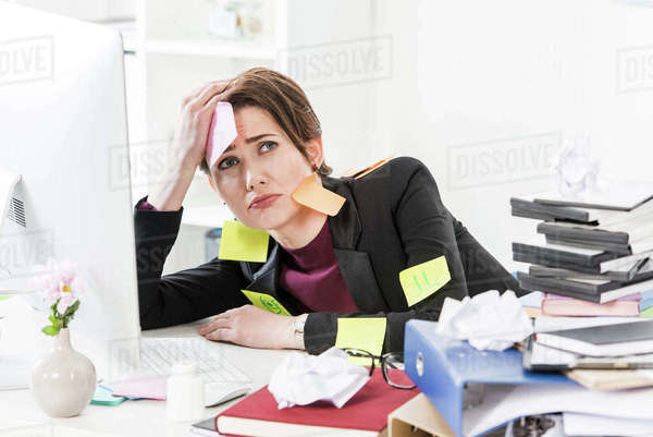 Sad attractive businesswoman sitting with stickers on face and clothes ...