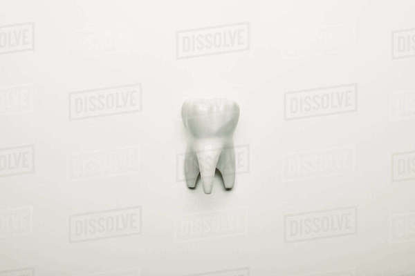 Top view of tooth model on white tabletop, dental care concept ...