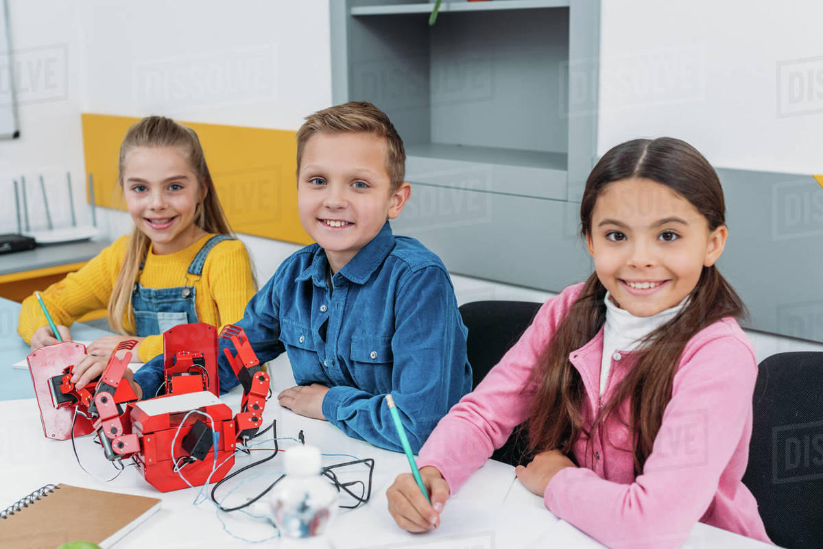 Happy pupils making robot during stem robotics lesson - Royalty-free ...
