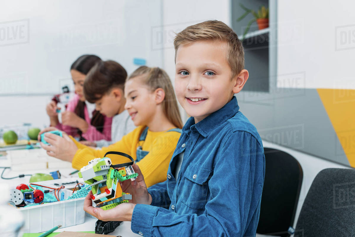 Boy showing colorful robot during stem robotics lesson - Stock Photo ...