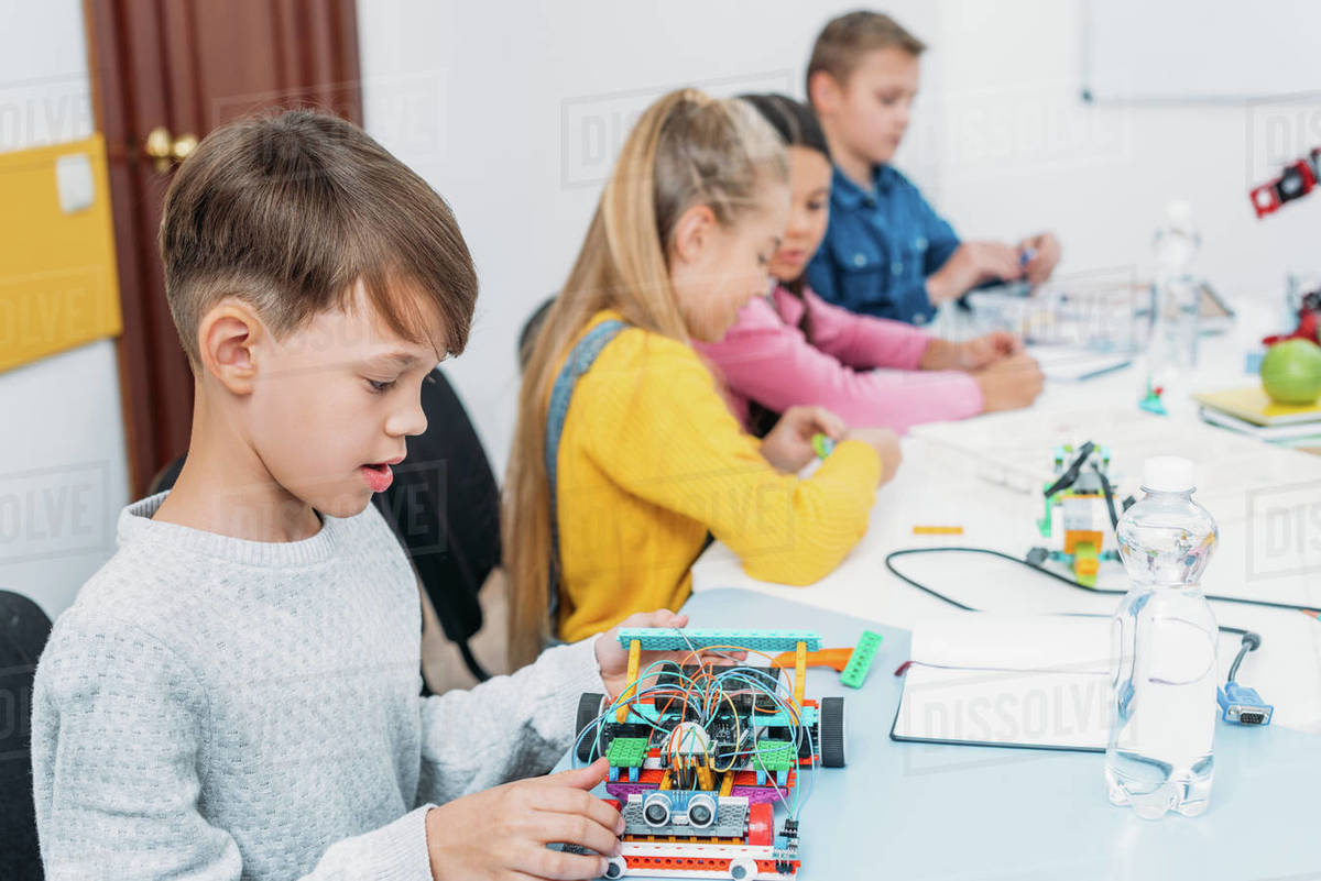 Focused children working together on stem project in classroom - Stock ...