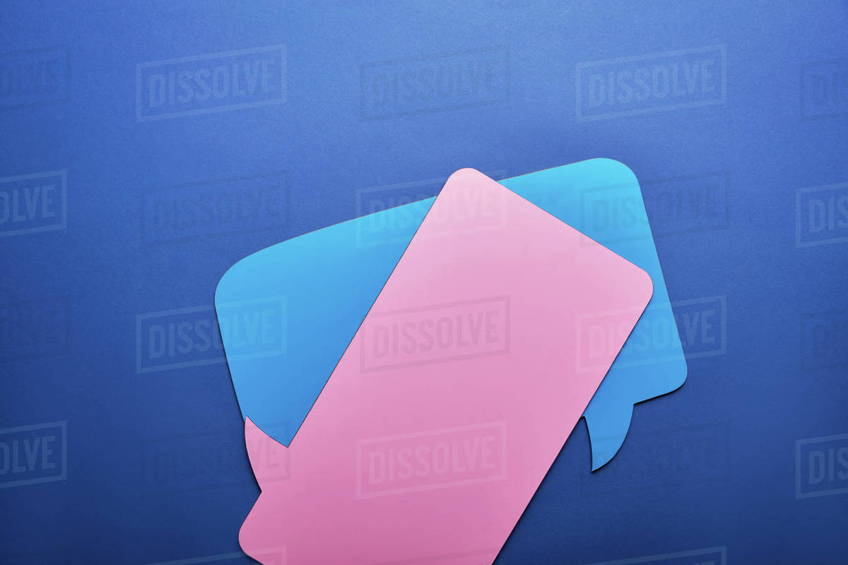 Elevated view of empty blue and pink speech bubbles on blue background ...