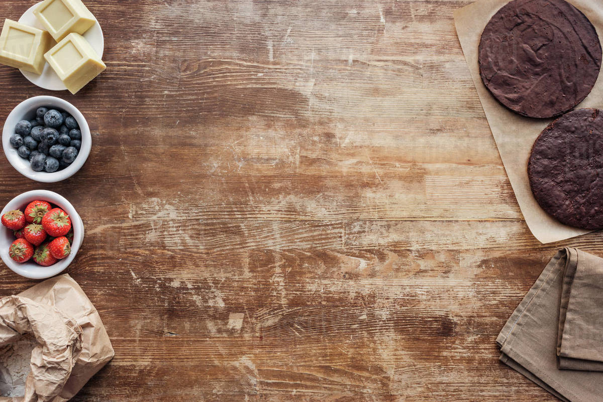 Top view of wooden table with ingredients for sweet homemade cake ...
