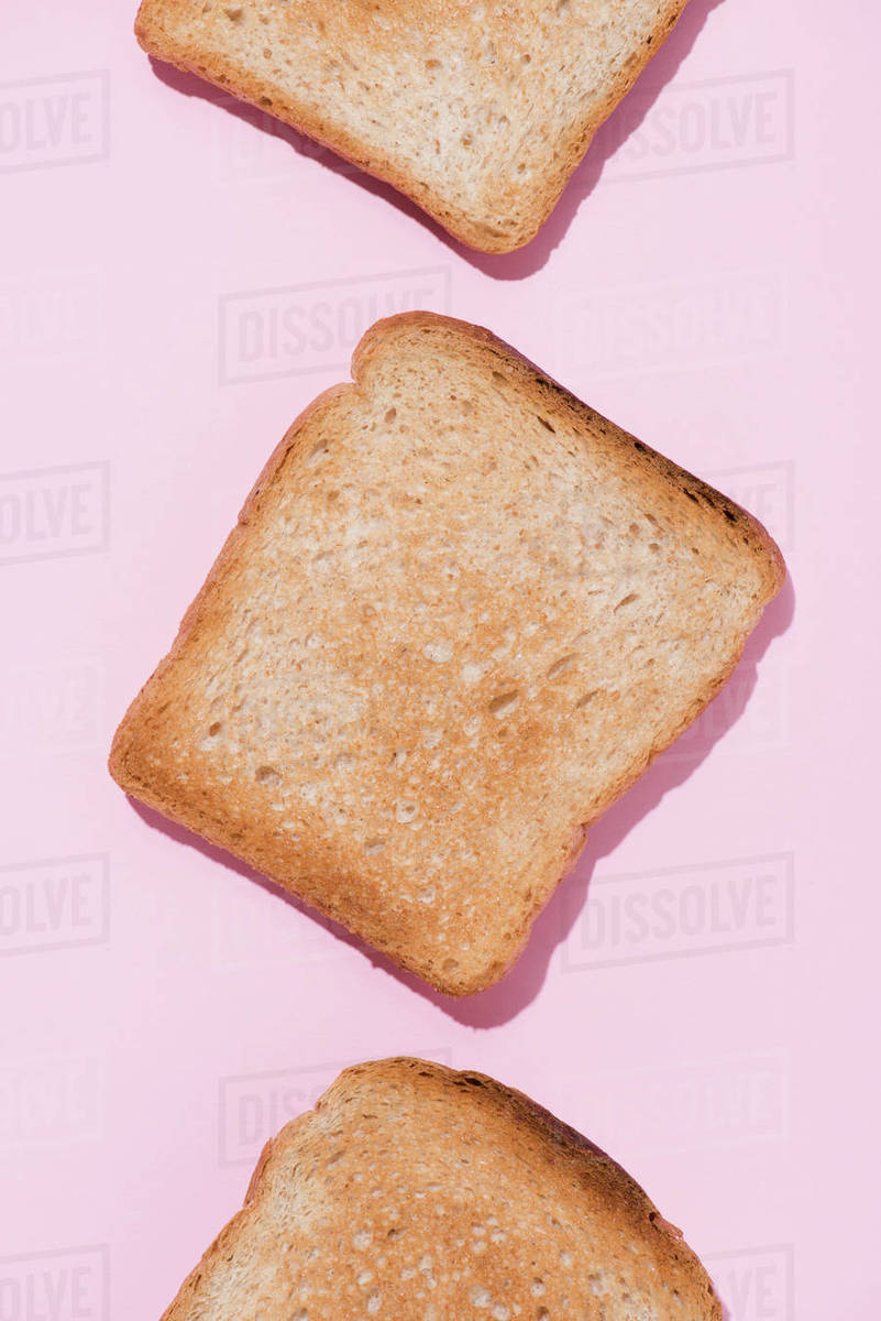 Top view of row of delicious toasts on pink tabletop - Royalty-free ...