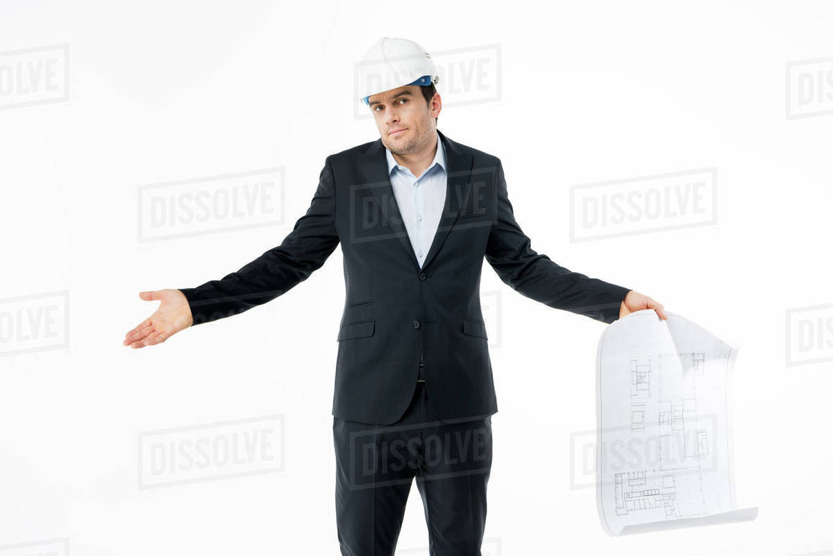 Confused male architect in hard hat holding blueprint isolated on white ...